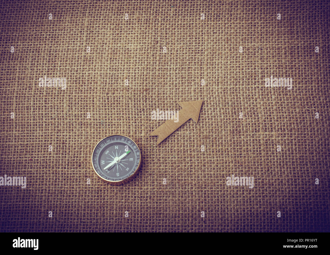 Compass and paper arrow on a canvas background Stock Photo - Alamy