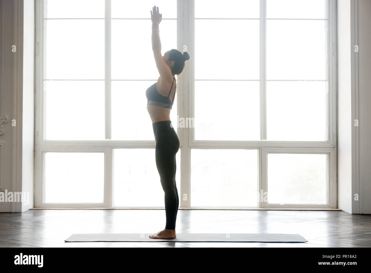 Young sporty attractive woman practicing yoga, doing mountain ex Stock ...