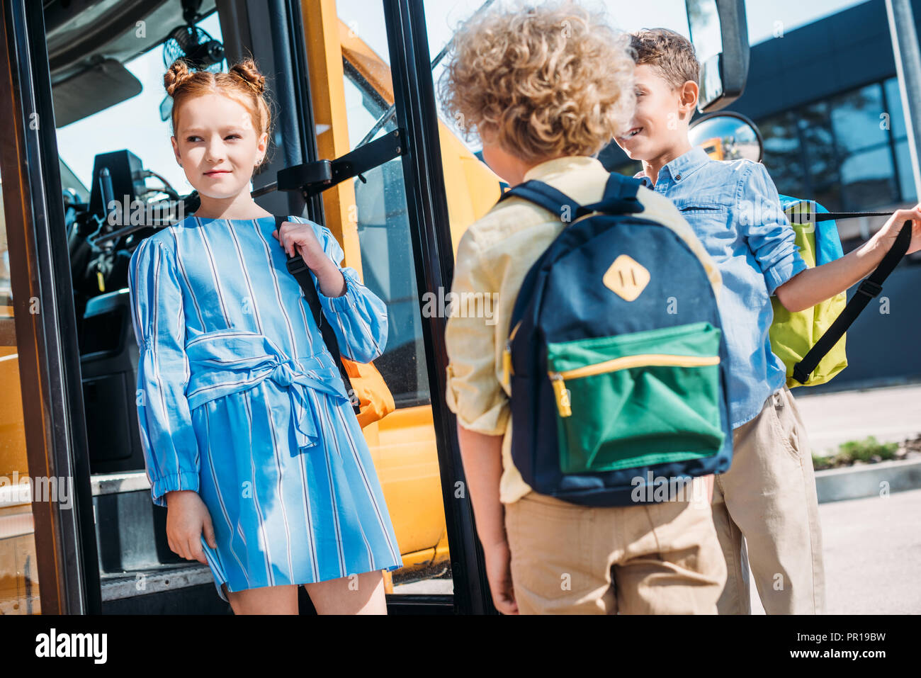Children talking school bus hi-res stock photography and images - Alamy