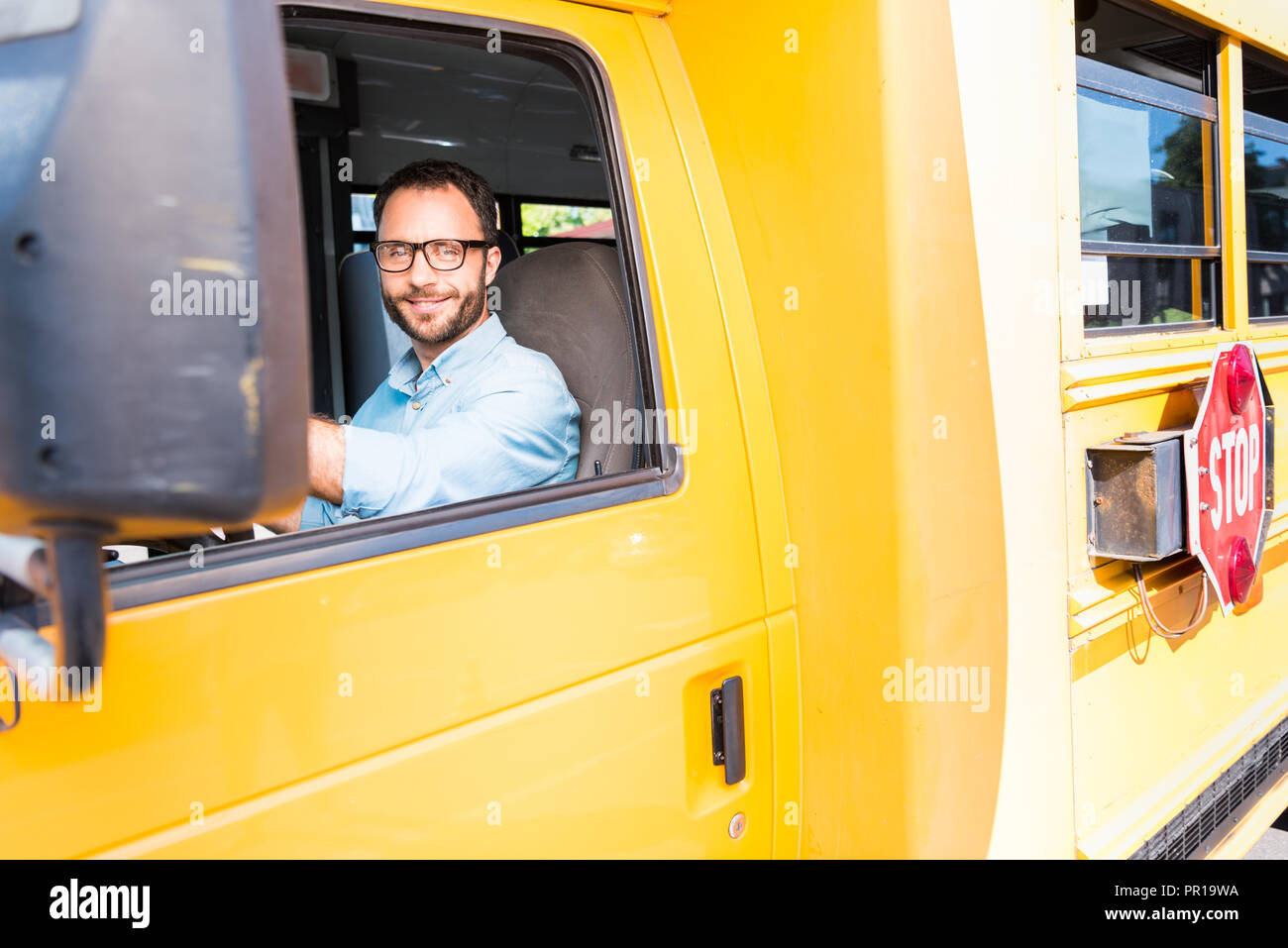 attractive happy school bus driver looking at camera Stock Photo - Alamy