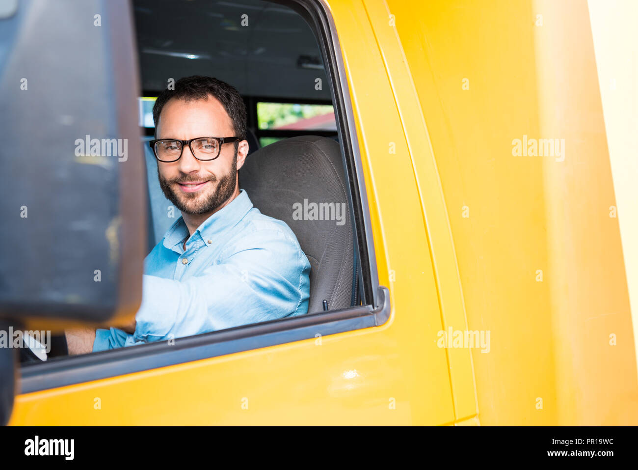 handsome happy school bus driver looking at camera Stock Photo - Alamy