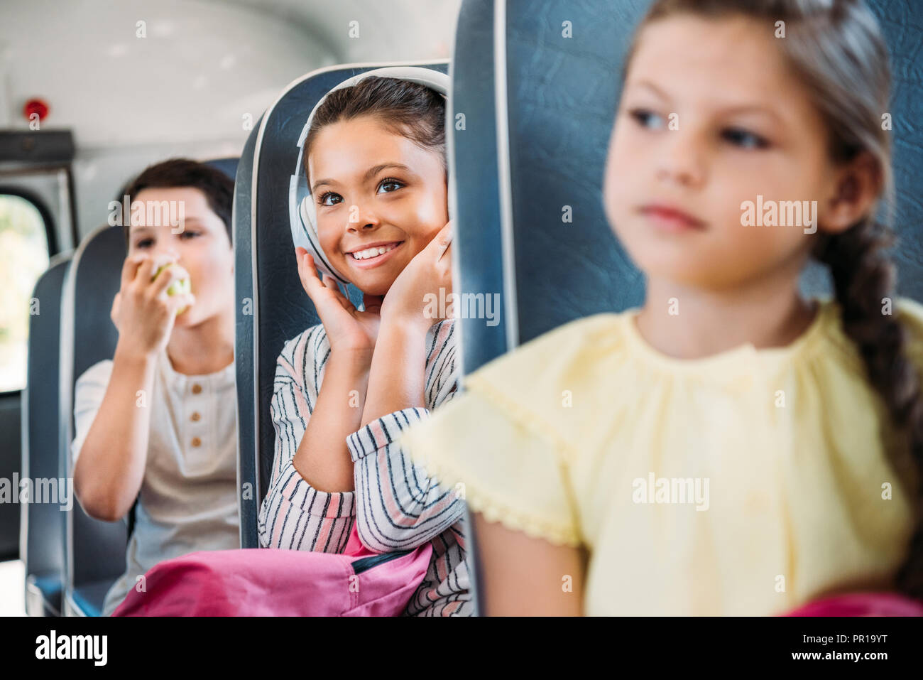 group of schoolchildren riding on school bus during school excursion ...