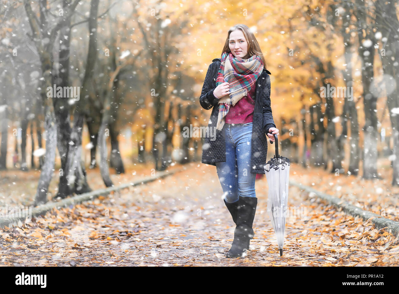 A girl in the park in the first snowfall Stock Photo - Alamy