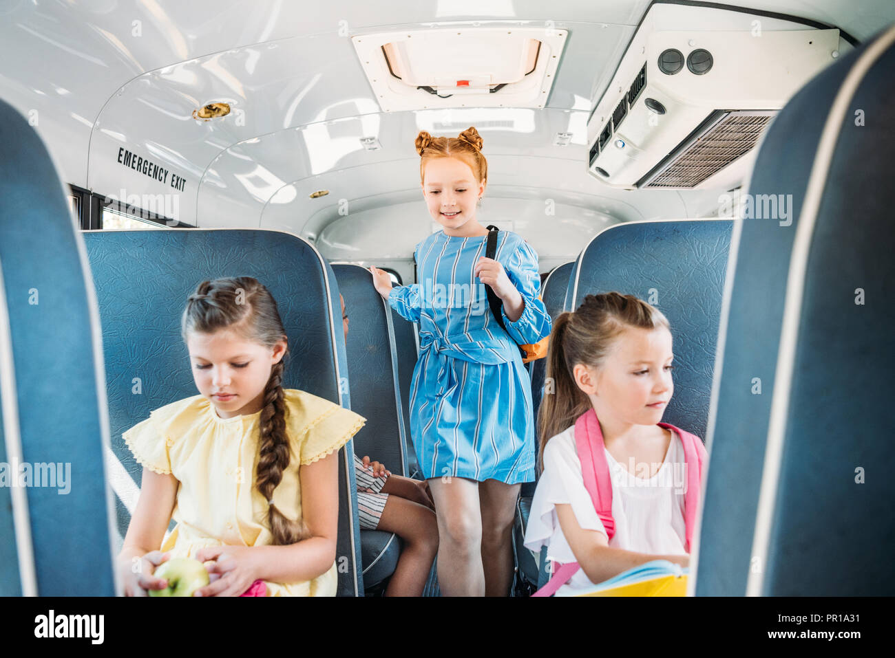adorable little pupils riding on school bus during excursion Stock ...