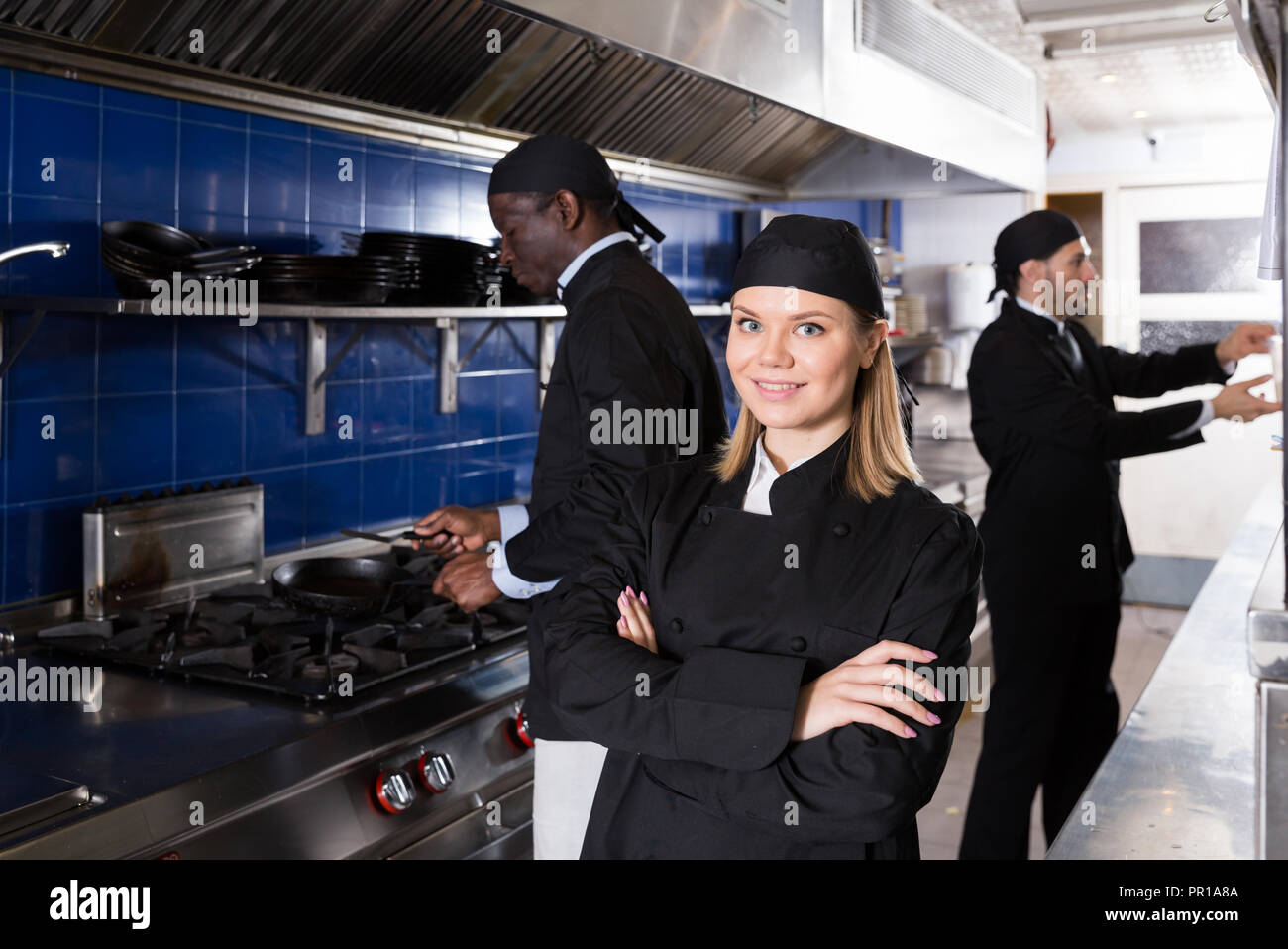Portrait of woman kitchener who is standing on kitchen in restaurant ...