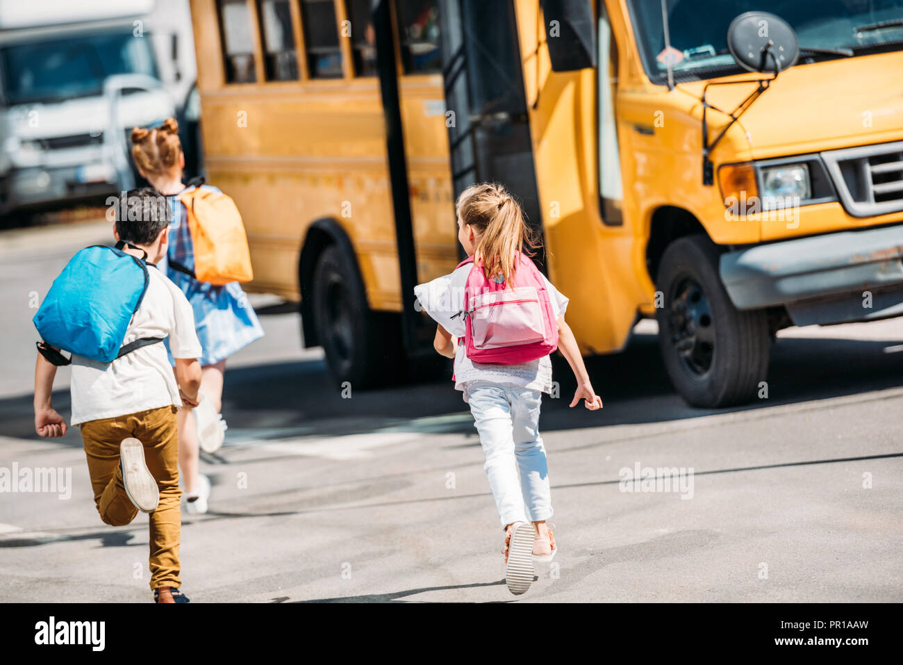Children running school bus hi-res stock photography and images - Alamy