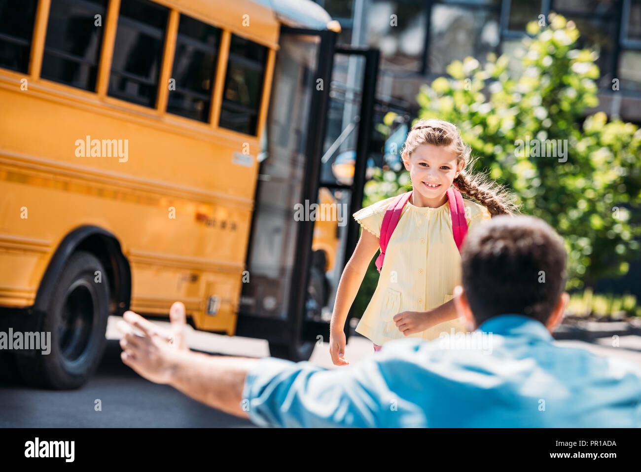 father with open arms waiting for happy little daughter while she ...