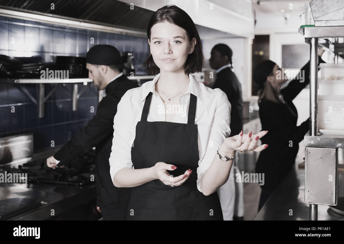 Portrait of woman waiter is posing stand on kitchen in restaurant Stock ...