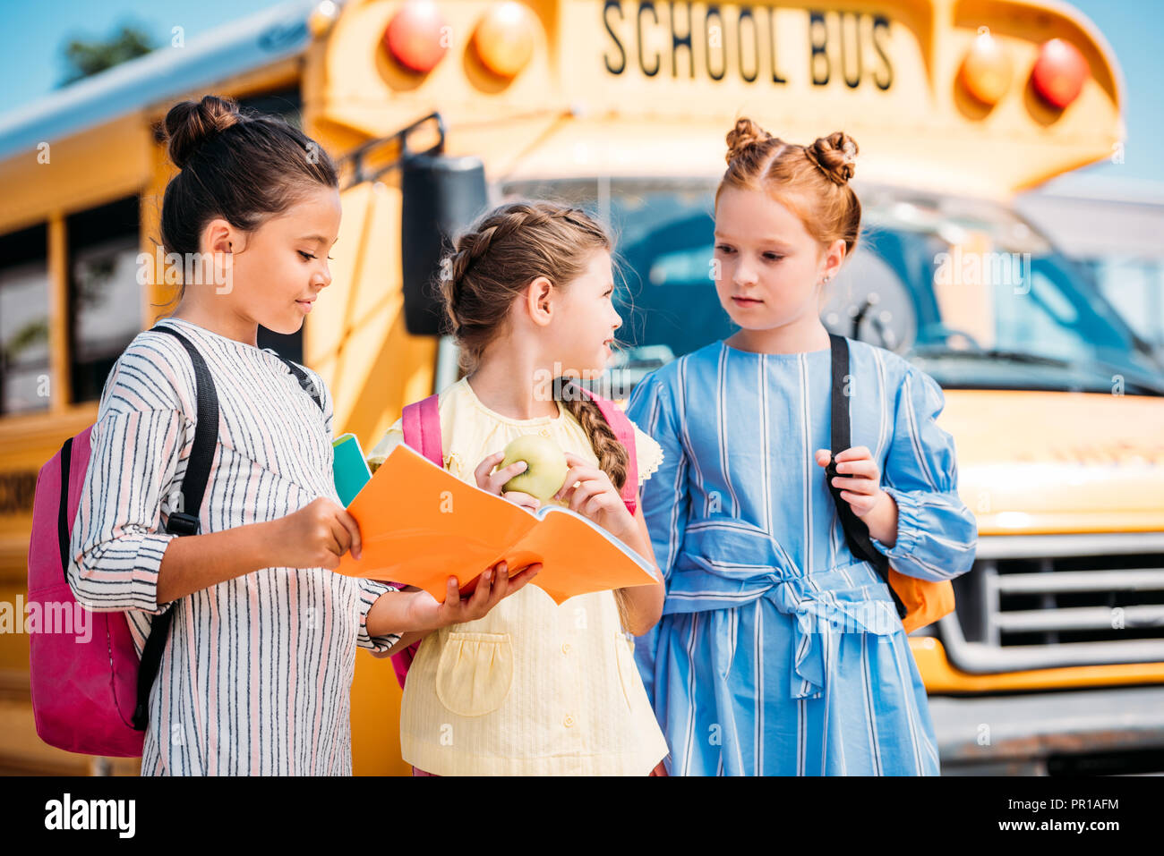 Children talking school bus hi-res stock photography and images - Alamy