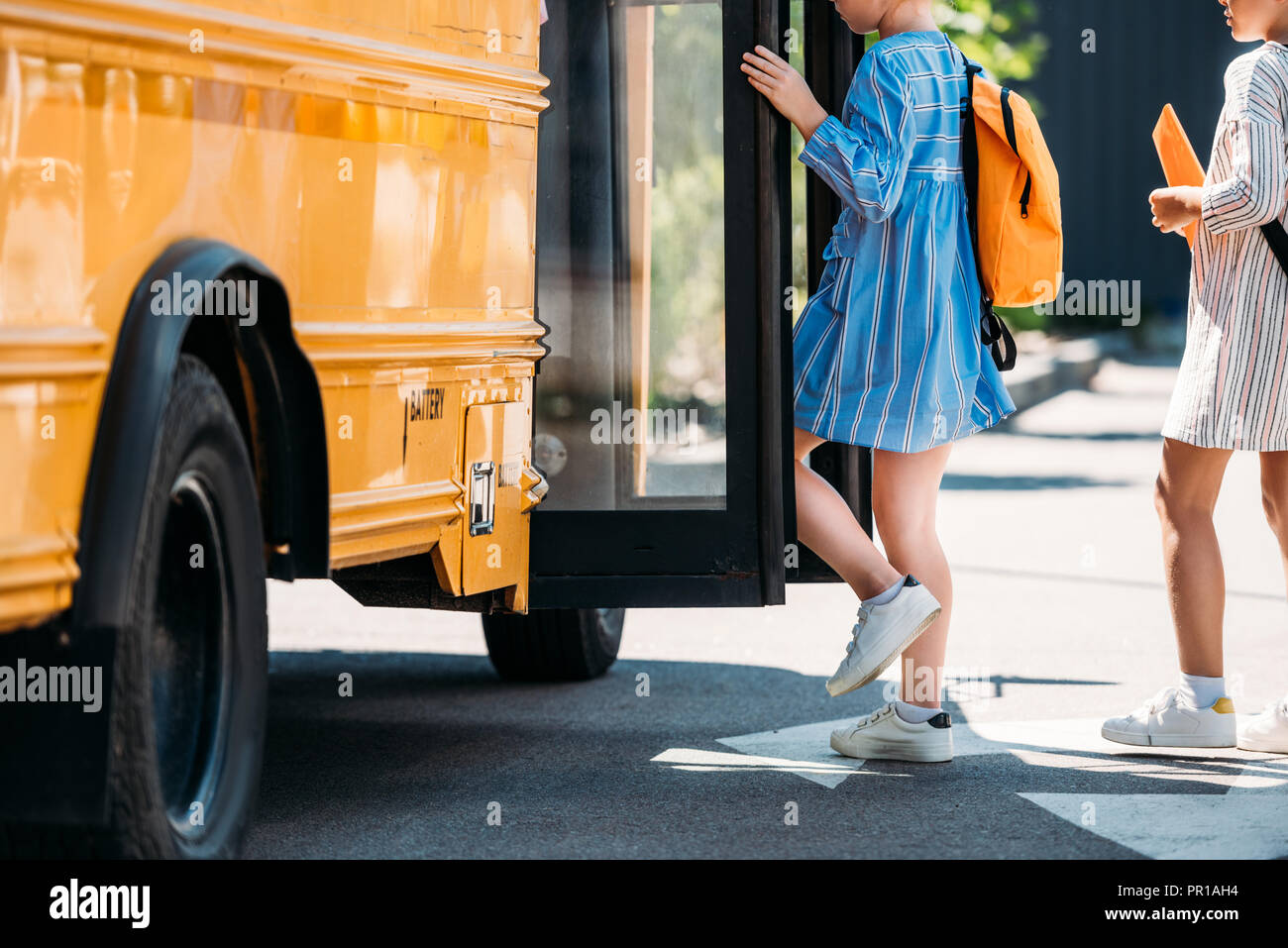cropped shot of schoolgirls entering school bus Stock Photo - Alamy