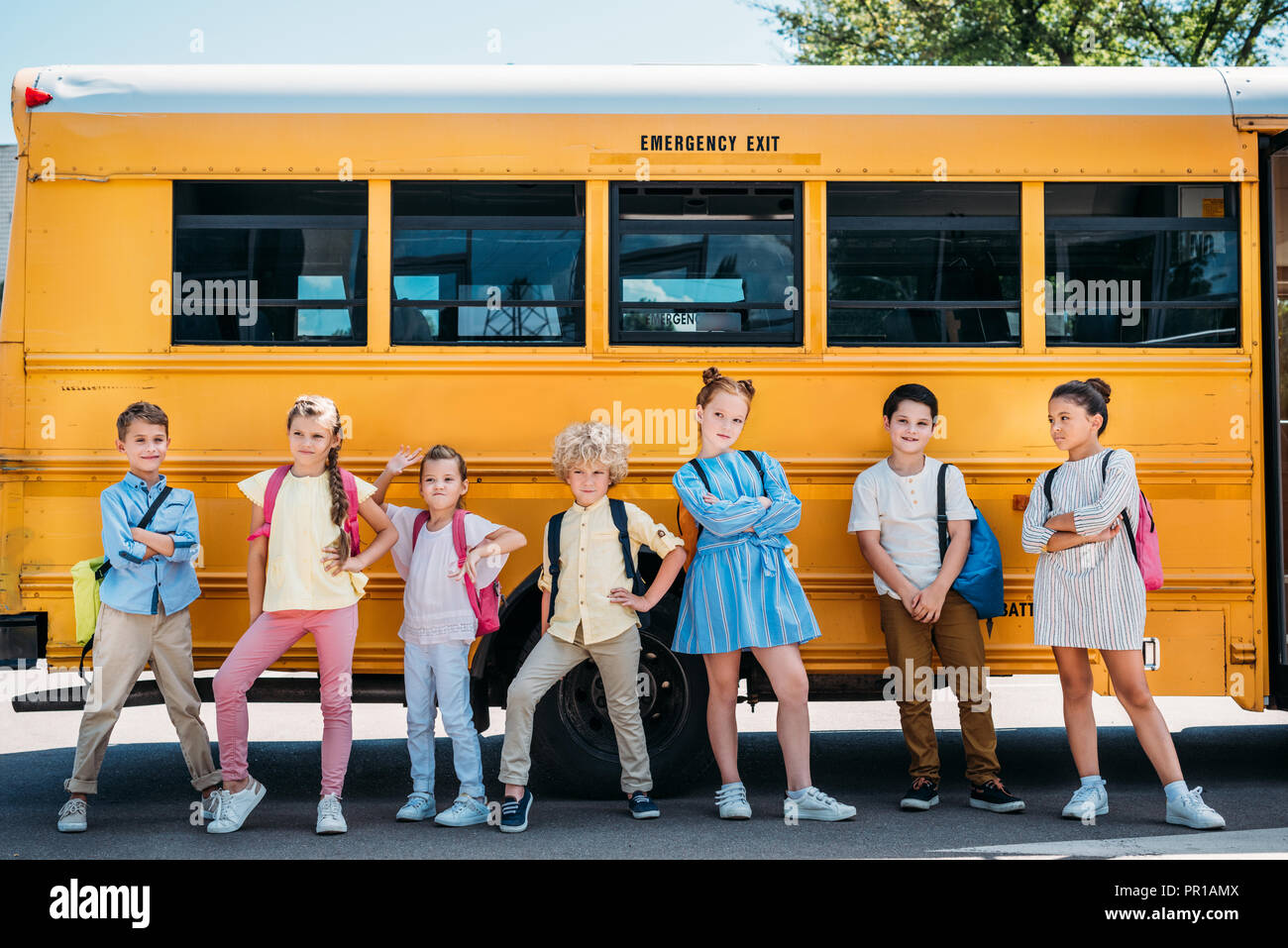 group of adorable schoolchildren posing in front of school bus Stock ...