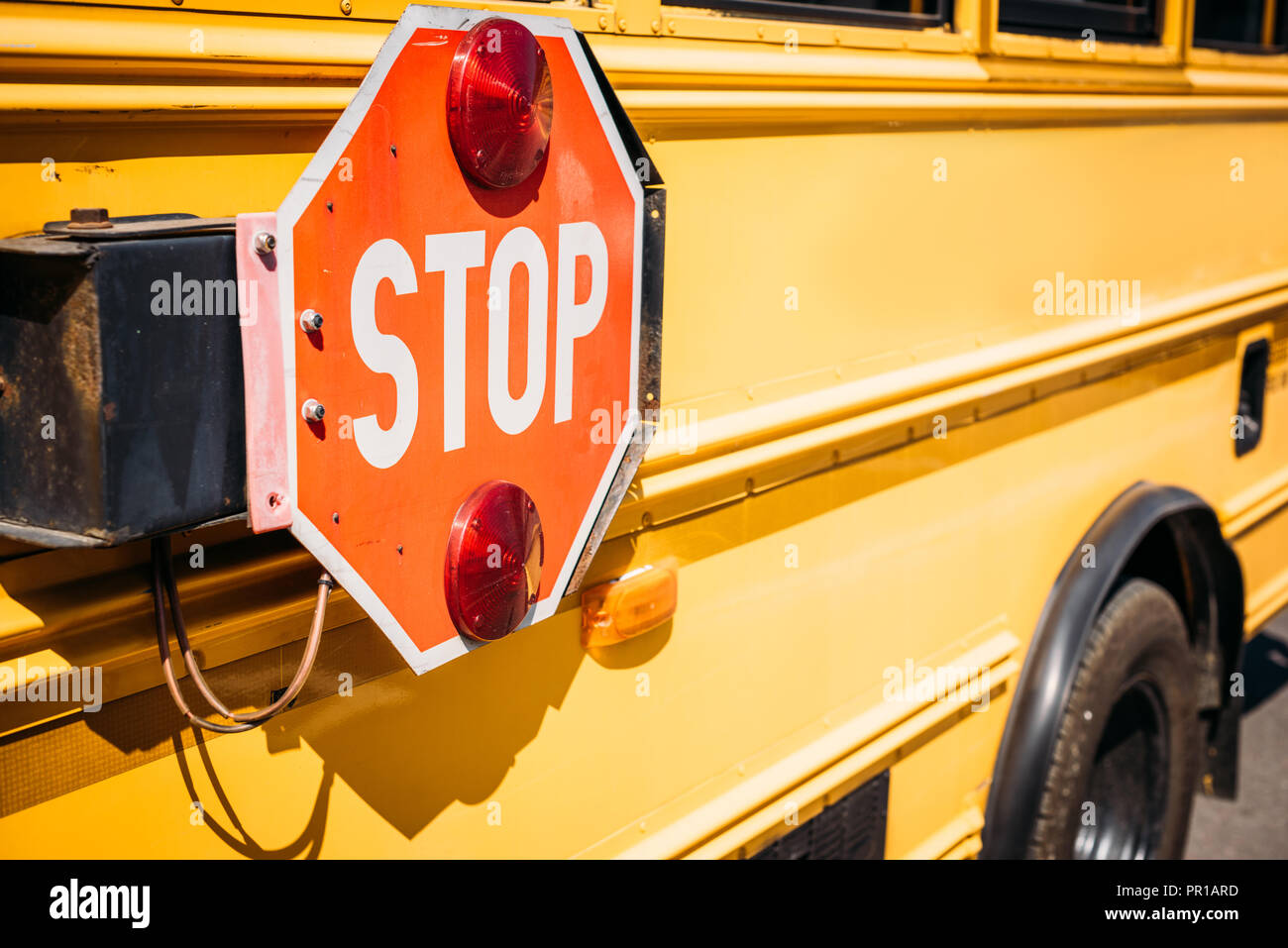 partial view of school bus with stop sign Stock Photo - Alamy