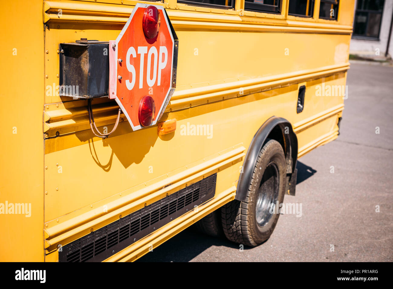 partial view of school bus with stop sign Stock Photo - Alamy