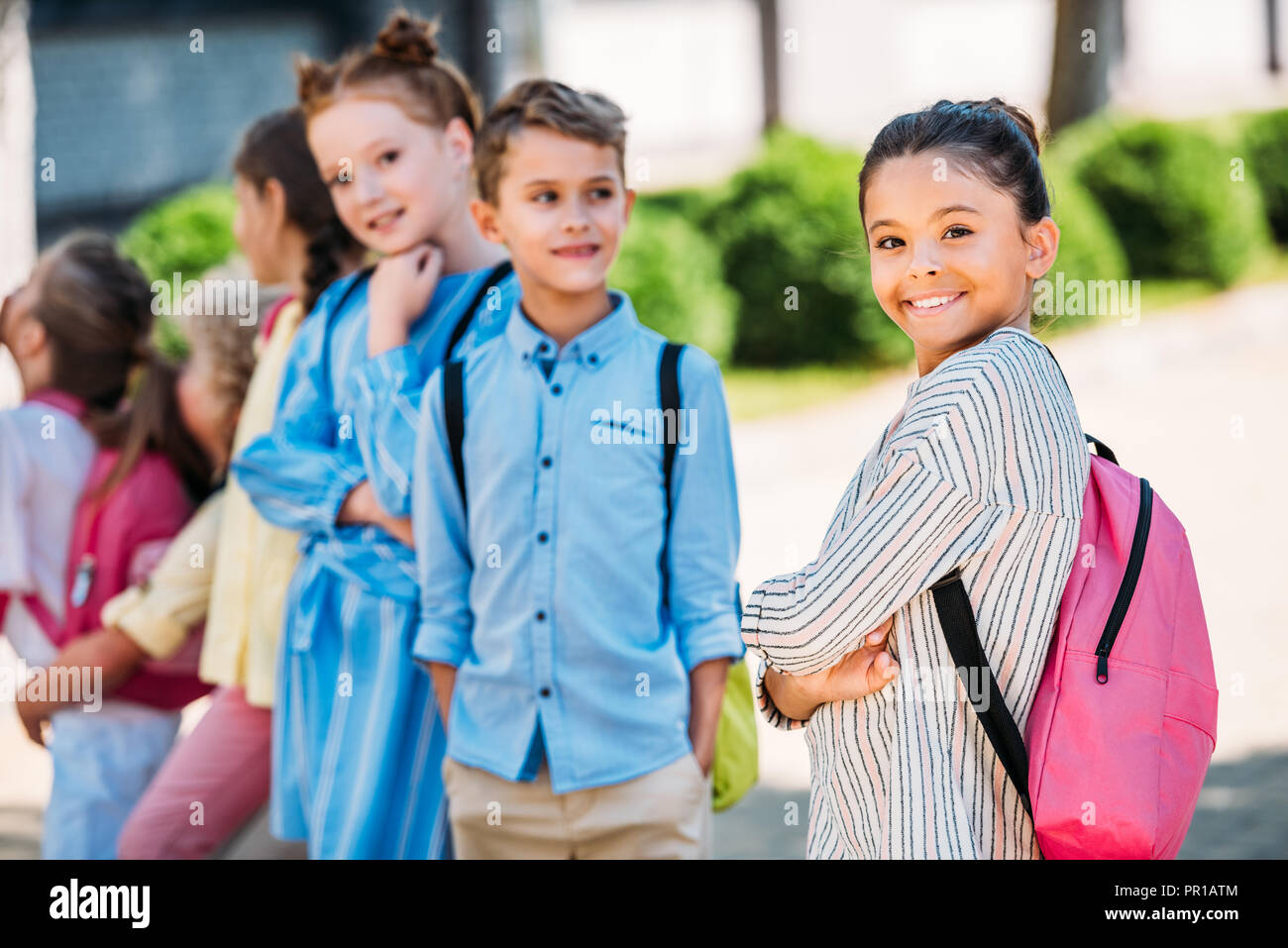 group of adorable schoolchildren spening time together after school ...