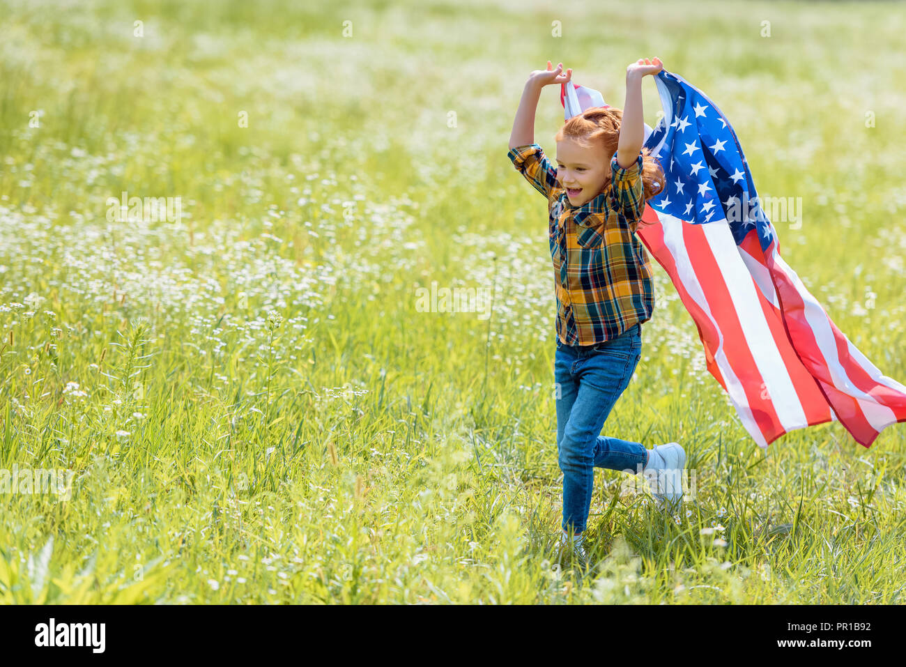 happy child running in field with american flag in hands Stock Photo ...