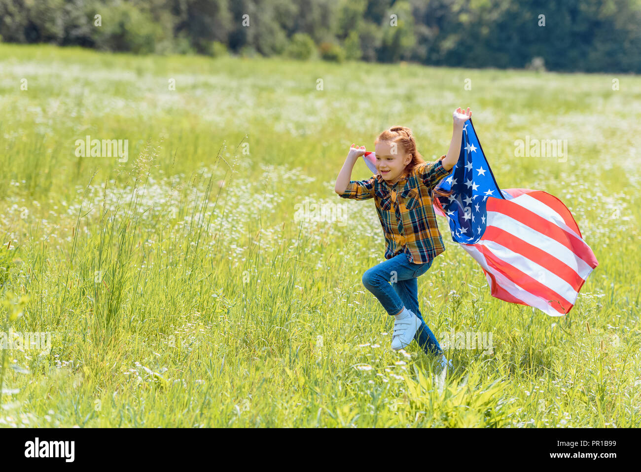 child running in field with american flag in hands Stock Photo - Alamy