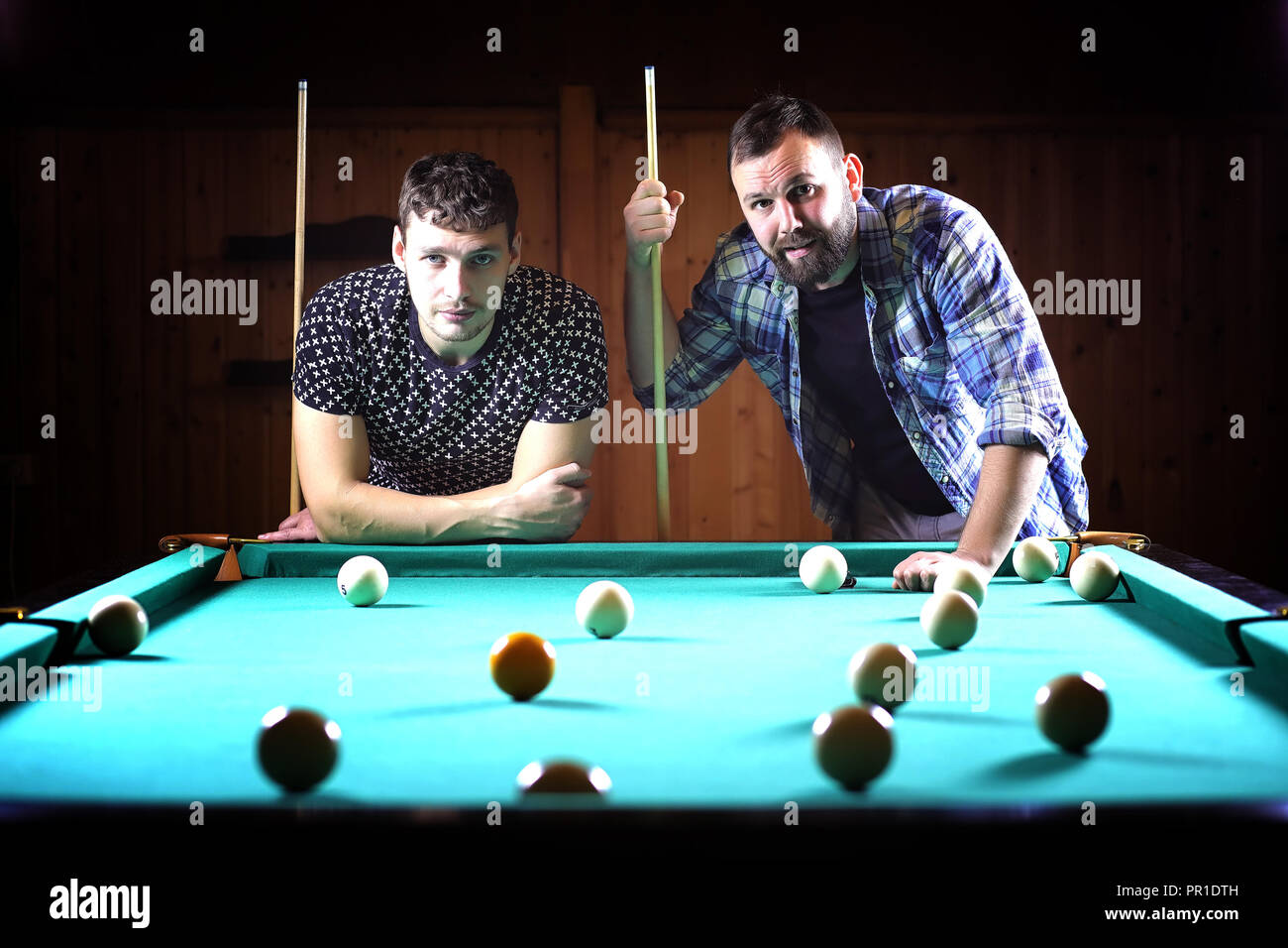 A man with a beard plays a big billiard. Party in a 12-foot pool Stock ...