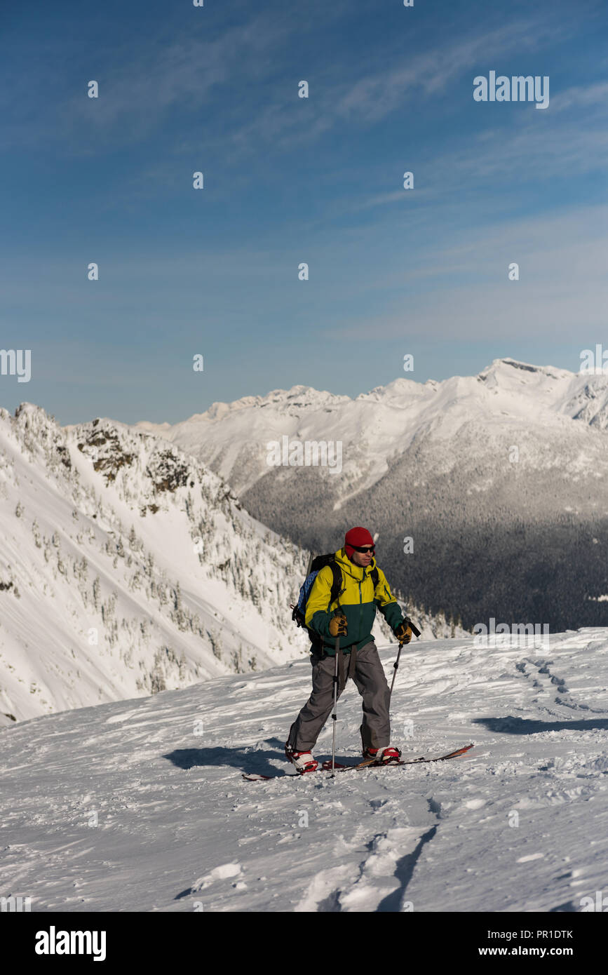 Male skier walking on a snowy mountain Stock Photo - Alamy