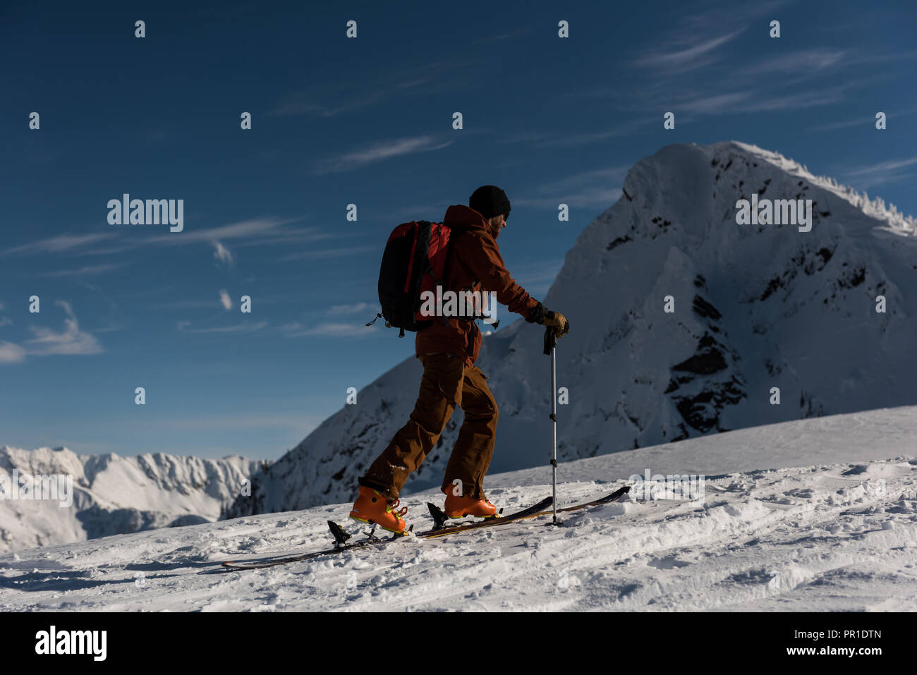Male skier walking on a snowy mountain Stock Photo - Alamy