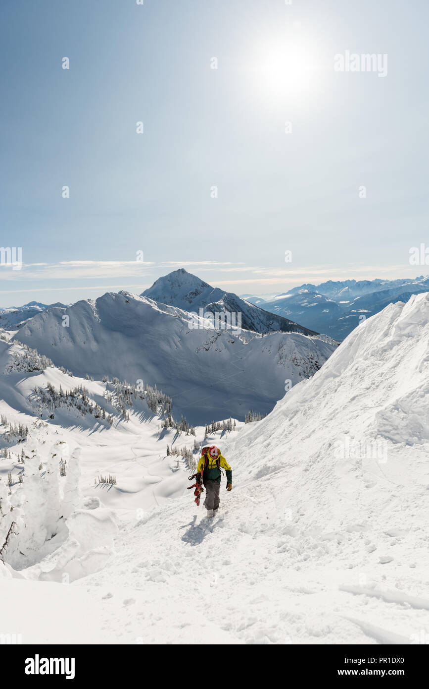 Skier walking with ski board on a snowy mountain Stock Photo - Alamy