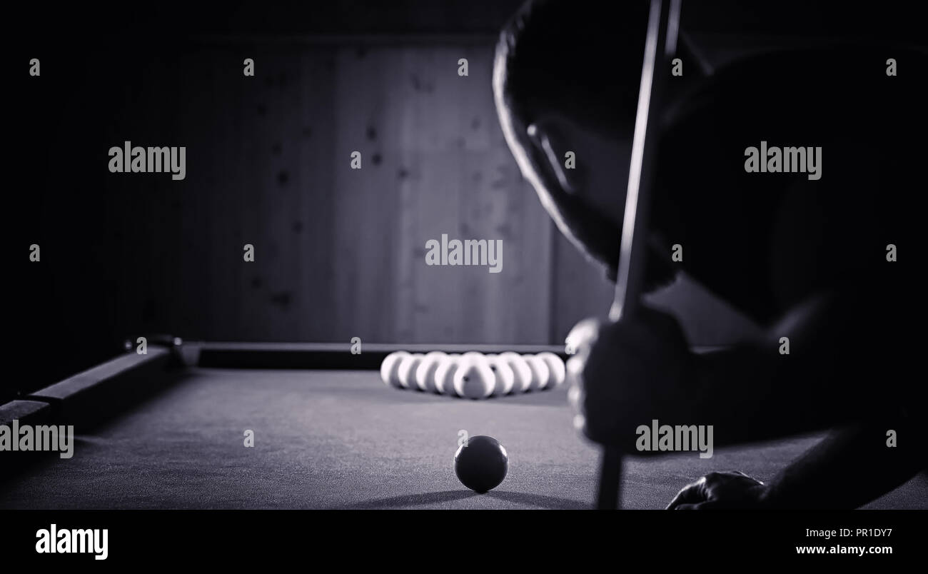 A man with a beard plays a big billiard. Party in a 12-foot pool Stock ...