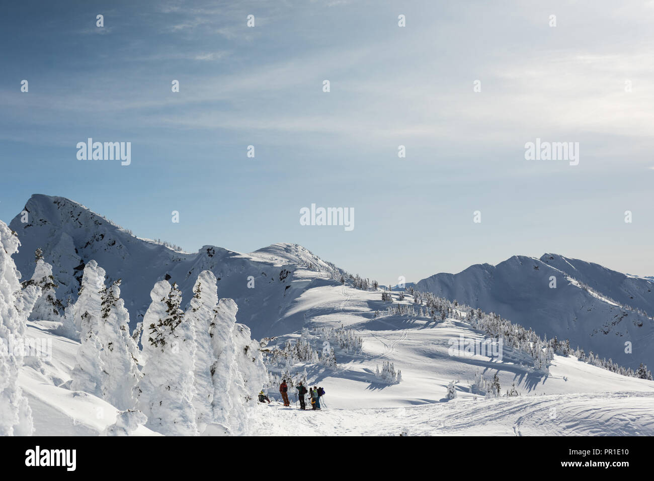 Group of skiers standing on a snowy mountain Stock Photo - Alamy