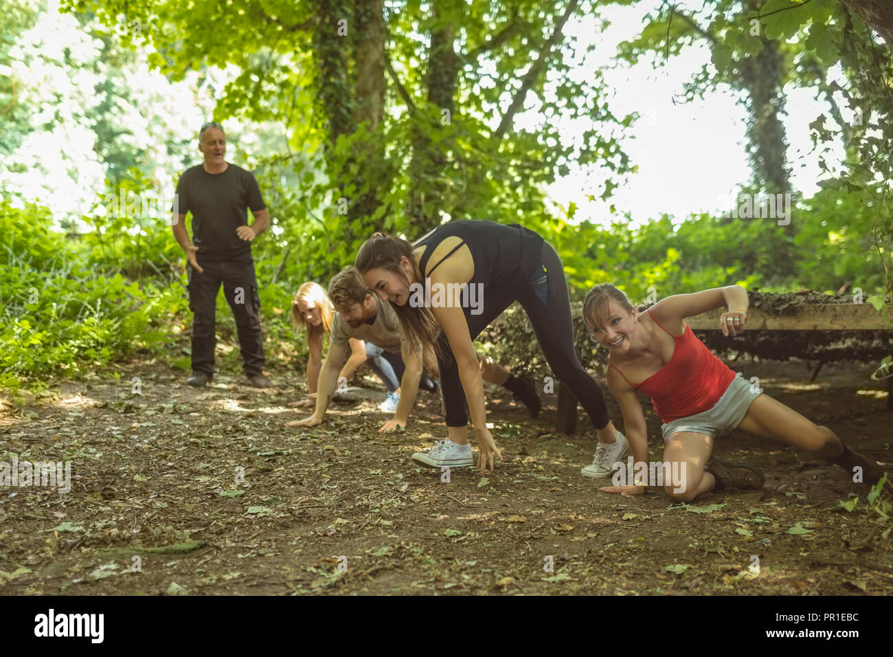 Fit people training over obstacle course Stock Photo - Alamy