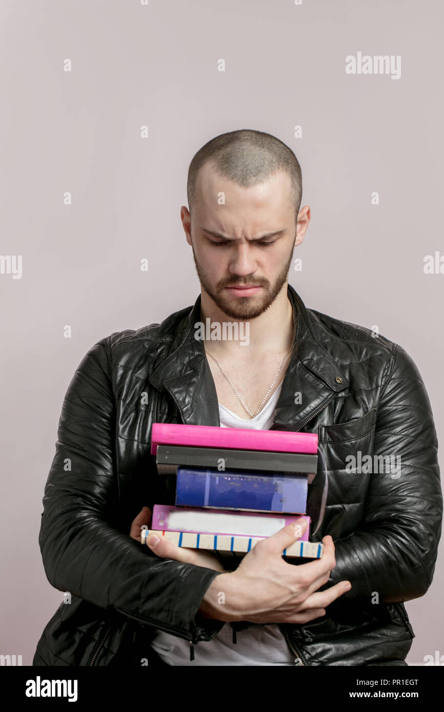 brutal strong man with a pile of books Stock Photo - Alamy