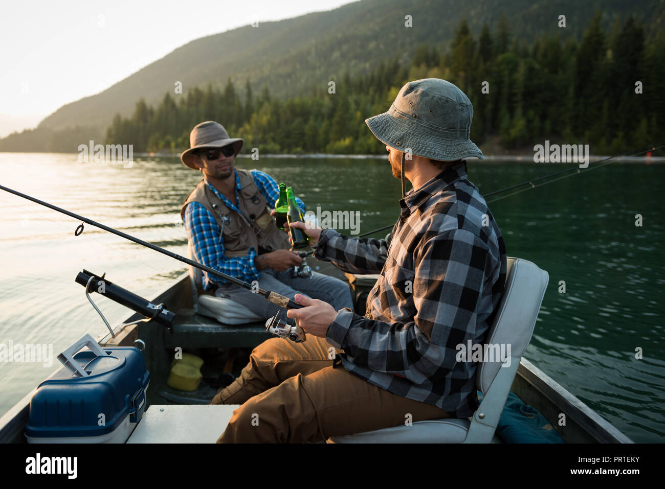 Two fishermen having beer while fishing in the river Stock Photo - Alamy