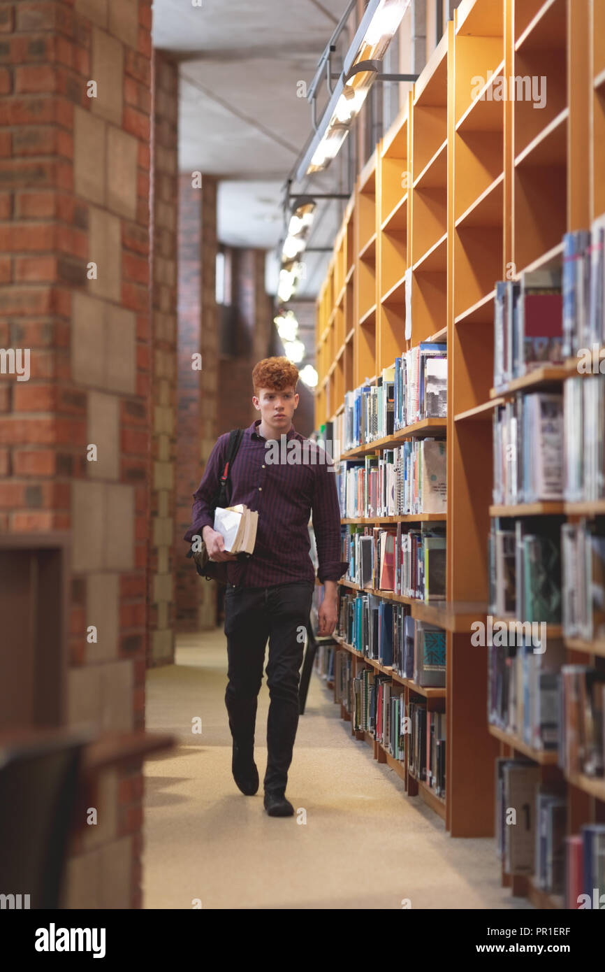 Man with books walking hi-res stock photography and images - Alamy