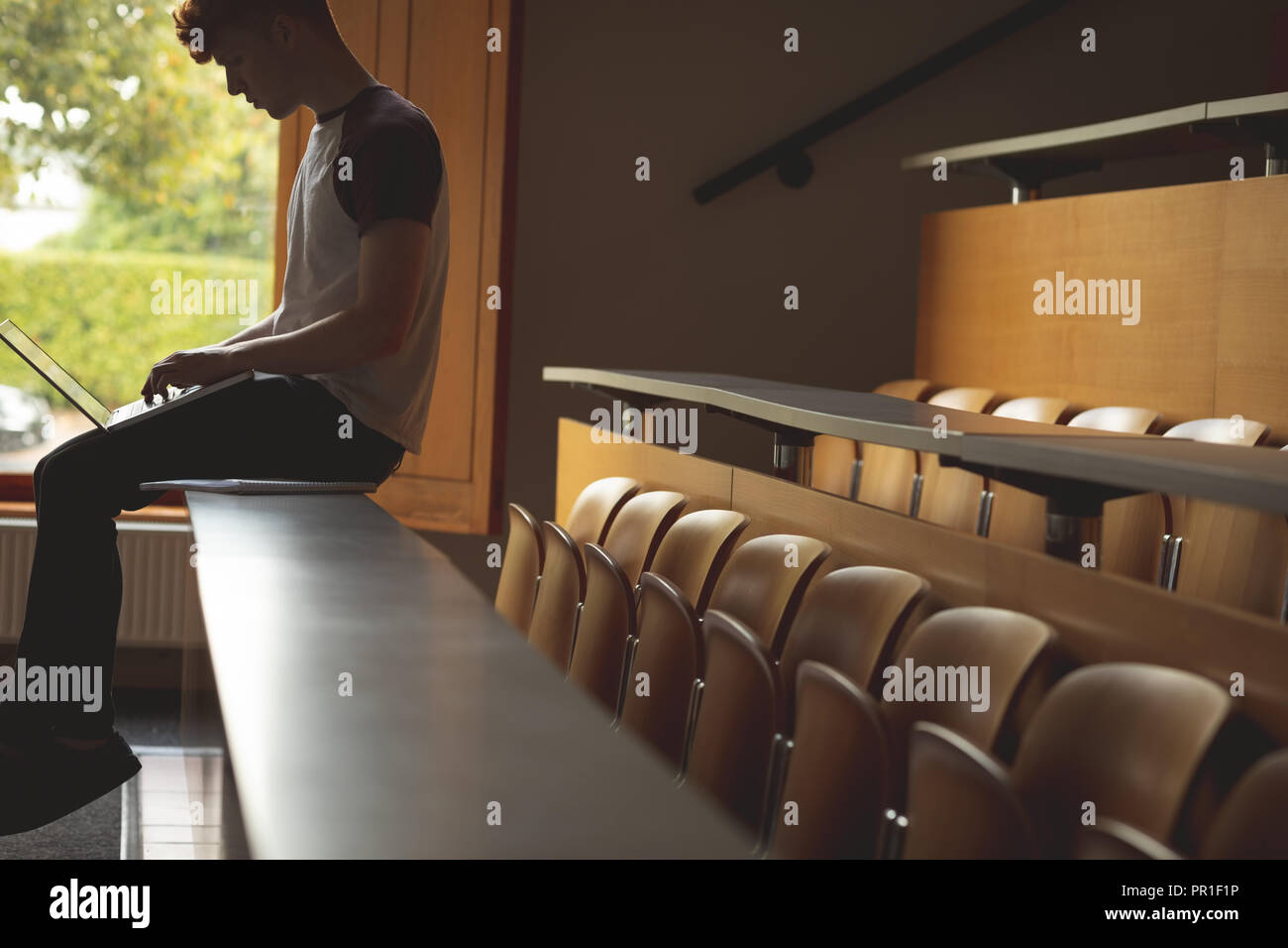 College student using laptop in classroom Stock Photo - Alamy