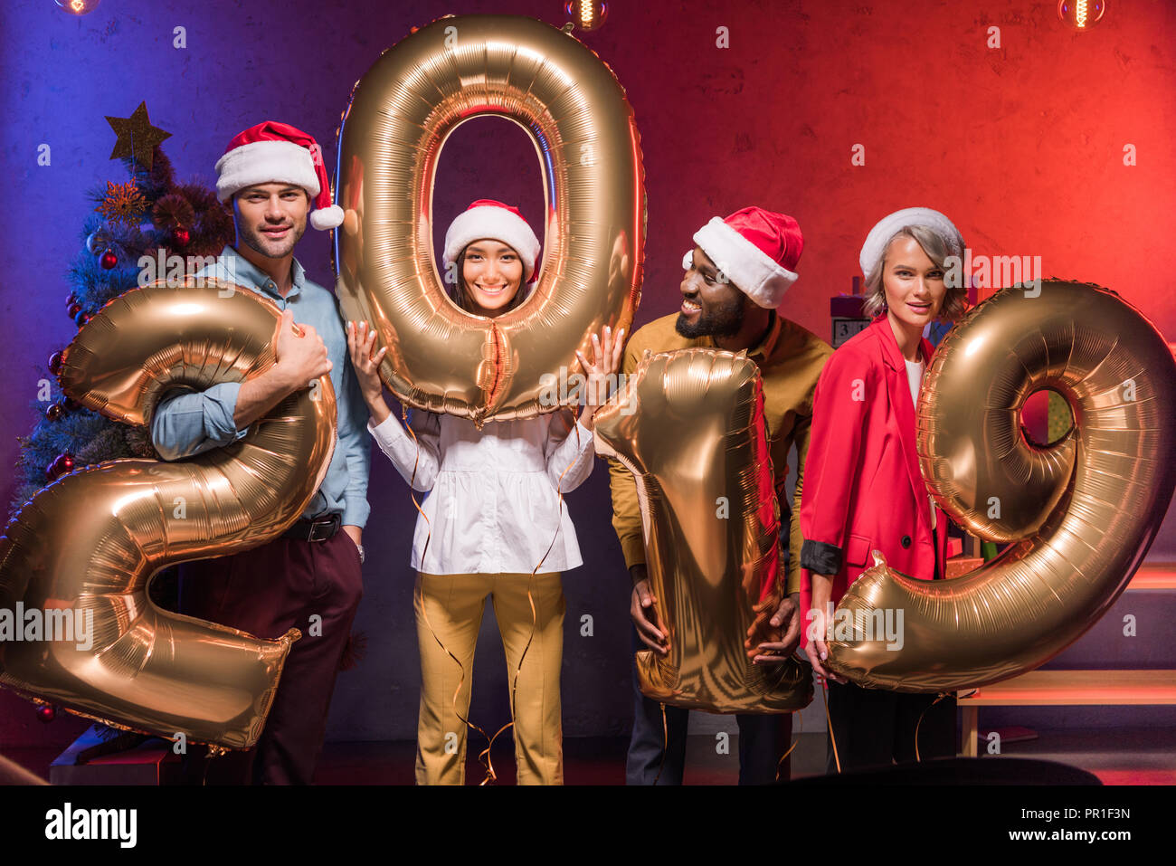 young multicultural managers holding 2019 balloons at new year ...