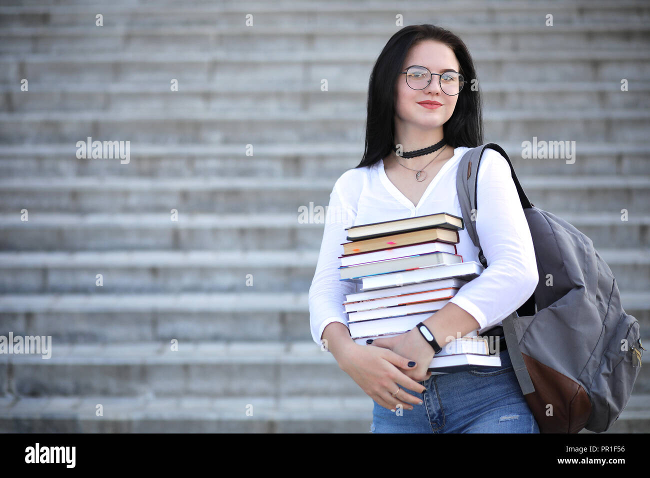 Girl student on the street with books Stock Photo - Alamy