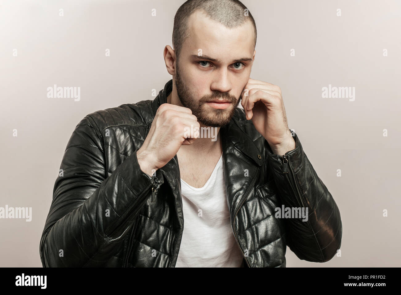 strong boxer dressed casually is going to kick somebody Stock Photo - Alamy