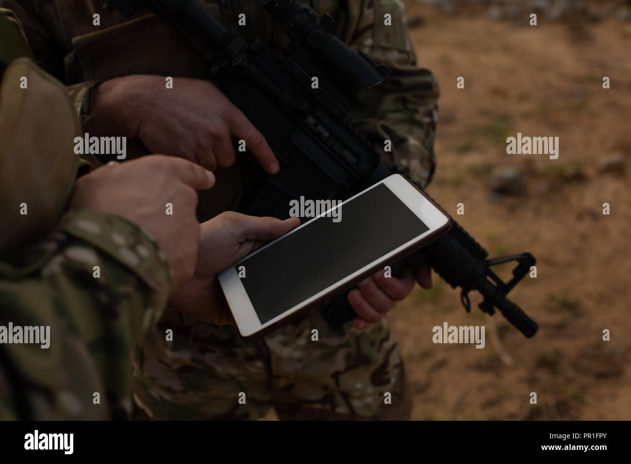 Military soldiers using digital tablet during military training Stock ...