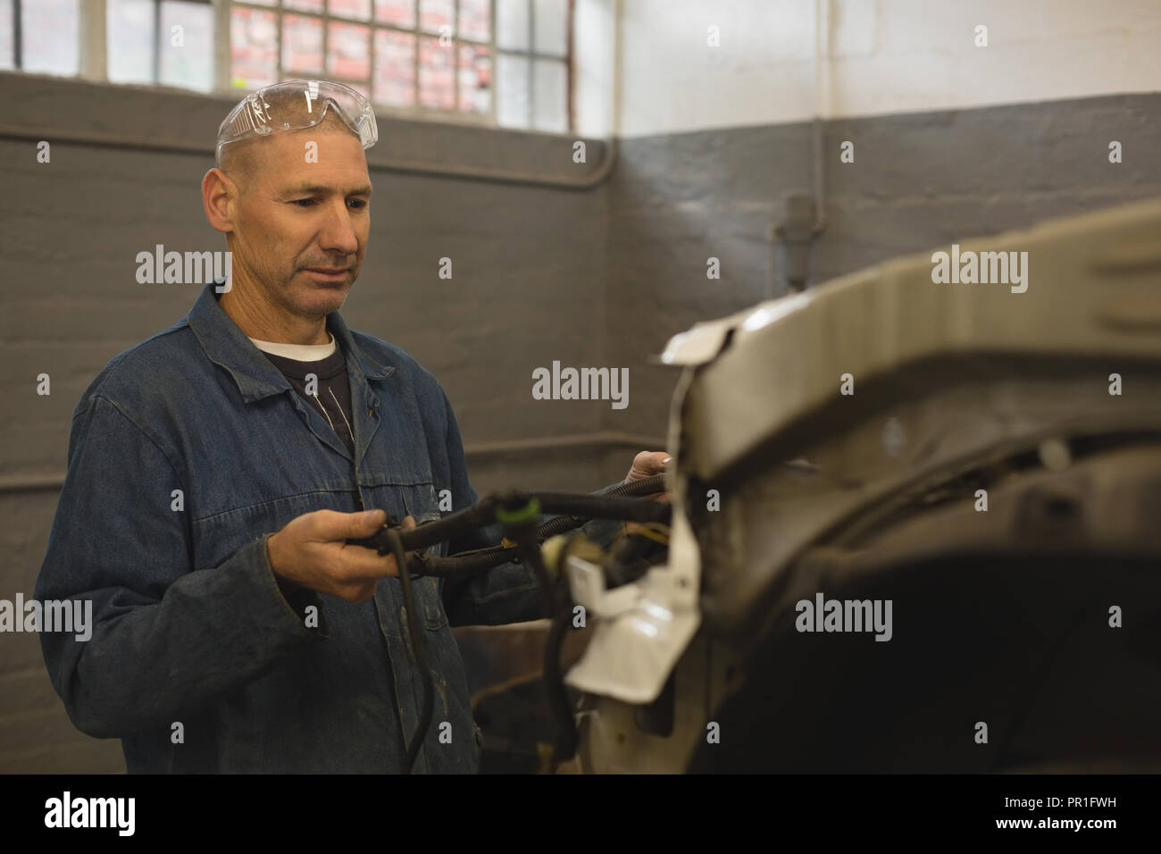 Male mechanic servicing a car Stock Photo - Alamy