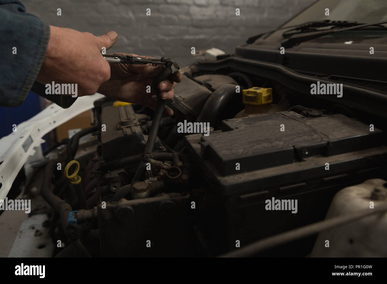 Male mechanic servicing a car Stock Photo - Alamy