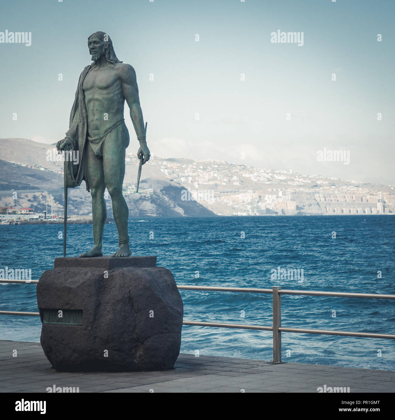 big masculine statue standing in front to the ocean Stock Photo - Alamy