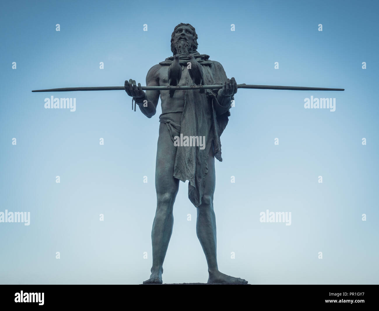big masculine statue standing in the blue Stock Photo - Alamy