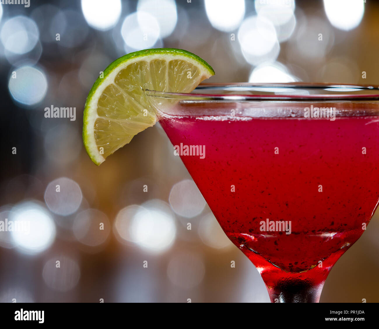 red chilled martini with small huckleberry seeds floating at the bottom ...