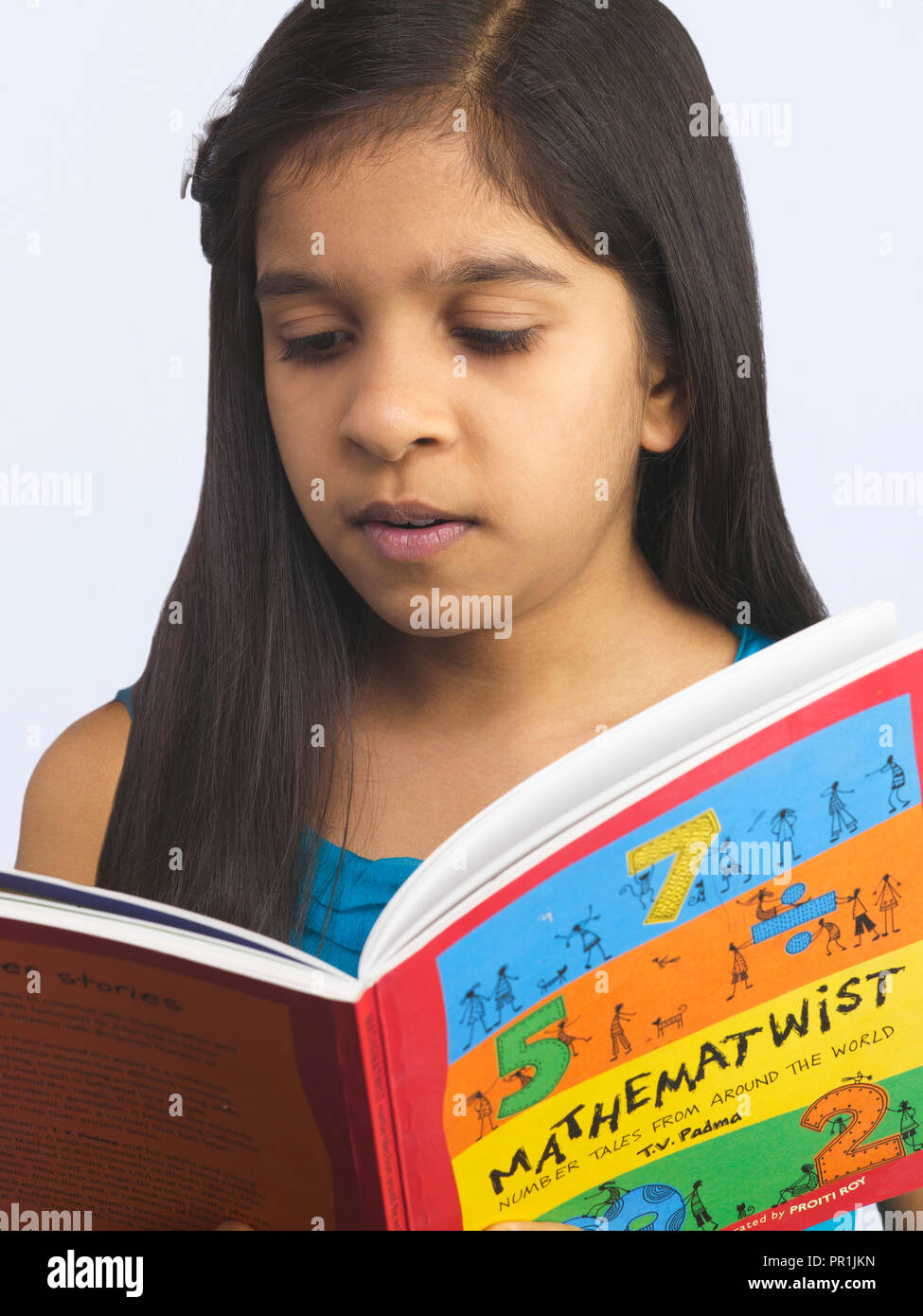 YOUNG GIRL READING A BOOK. AGAINST A PLAIN BACKGROUND Stock Photo - Alamy