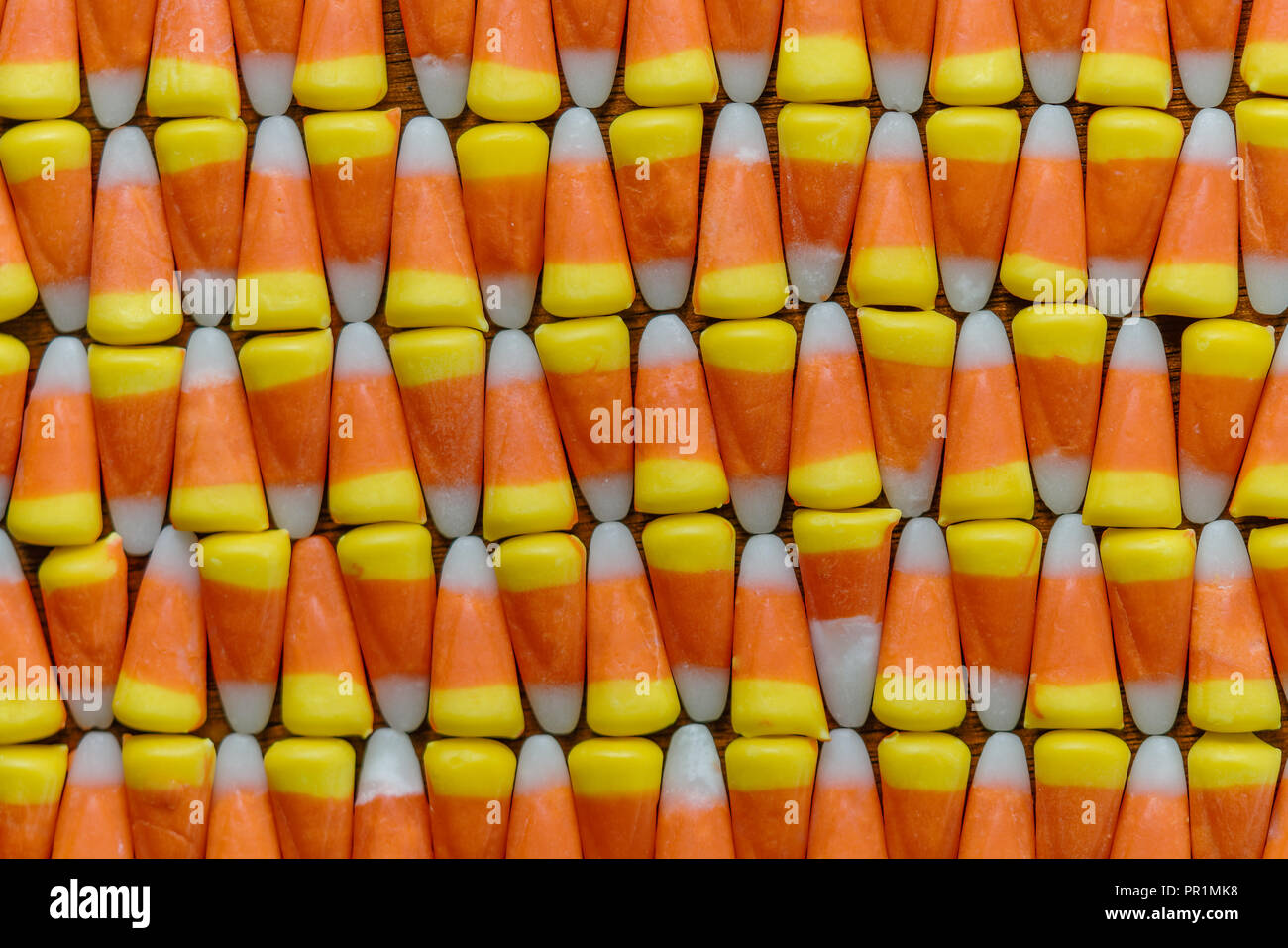 background of rows of candy corn background laid out in rows and ...