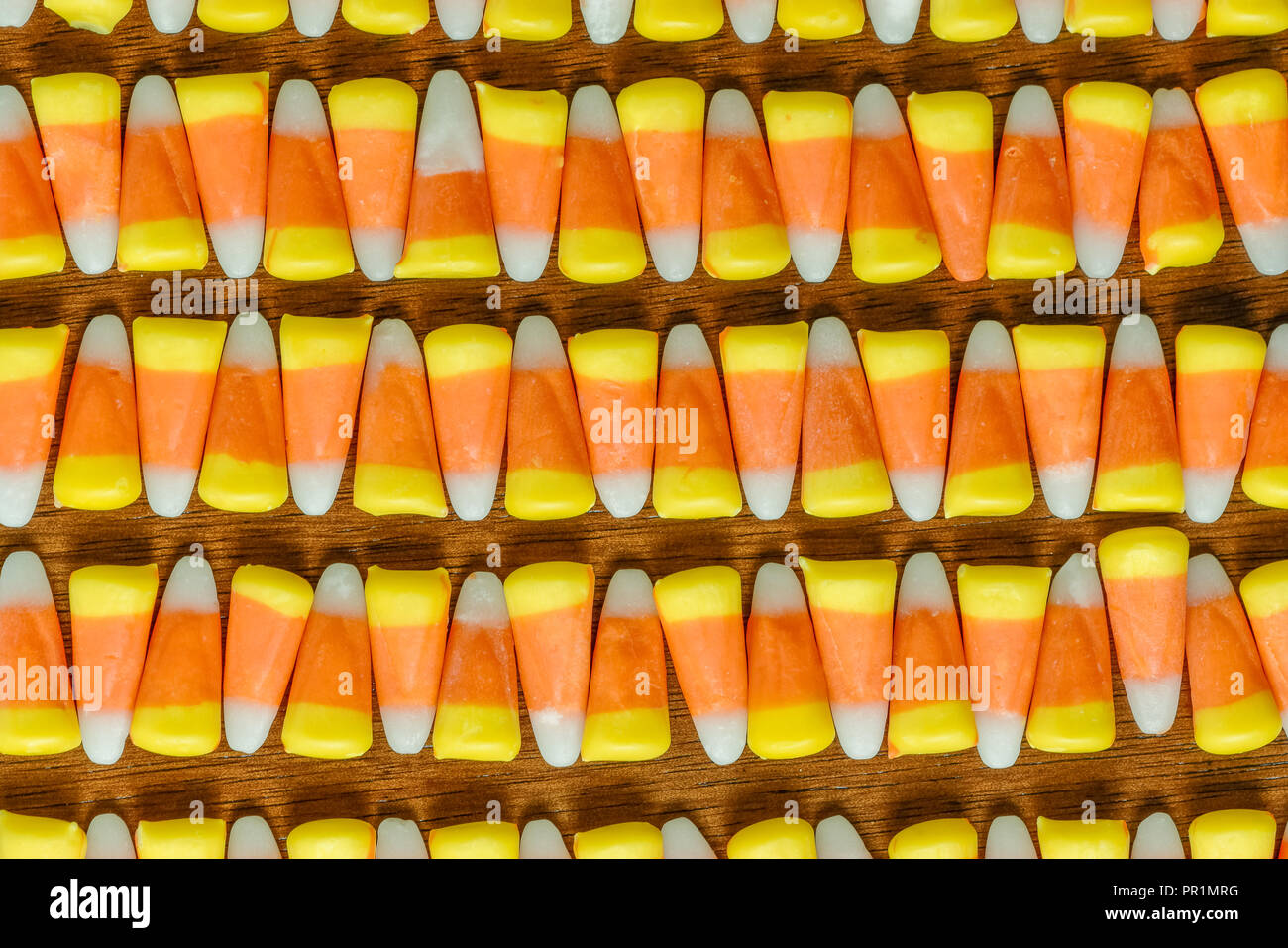 background of rows of candy corn background laid out in rows with space ...