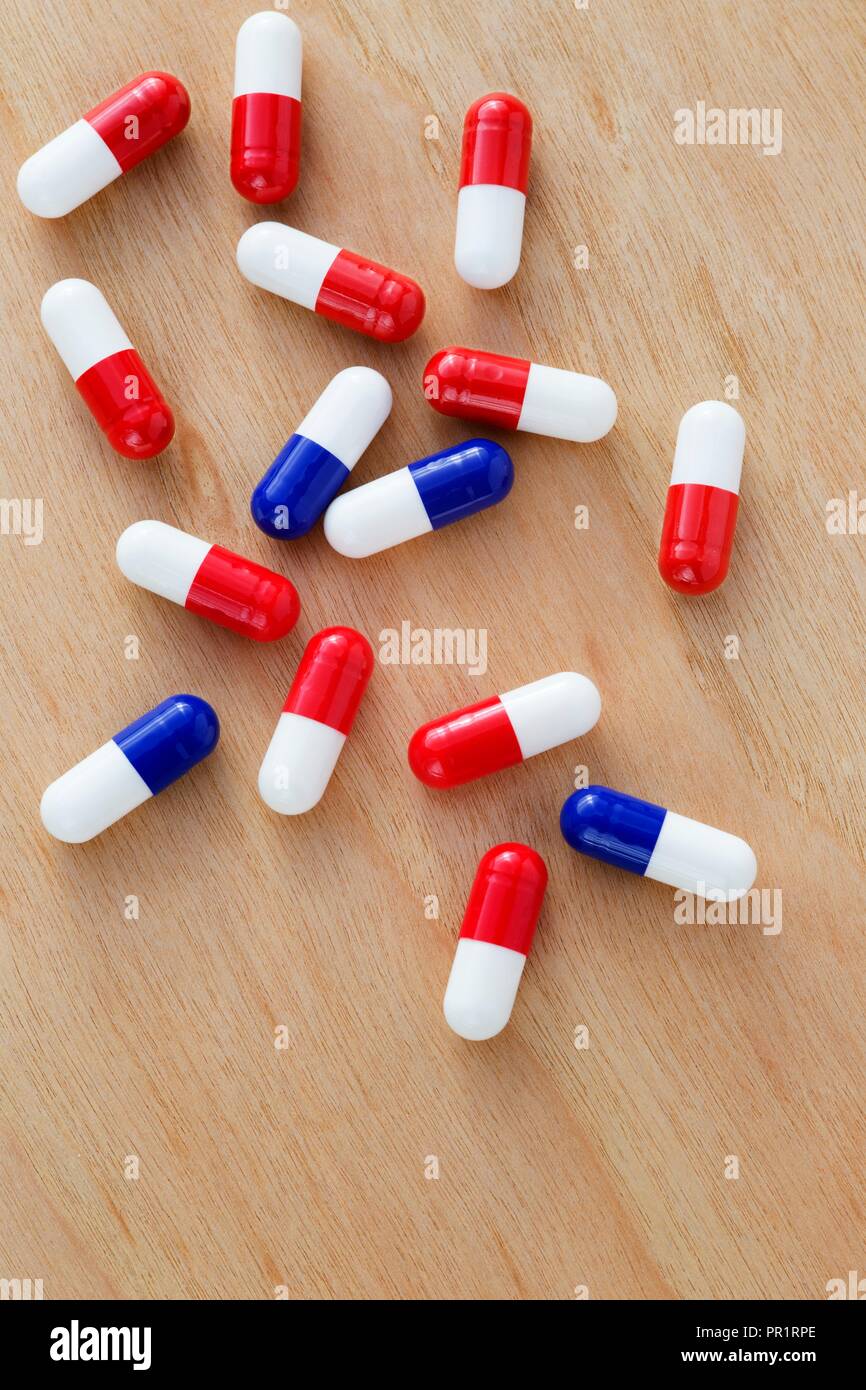 Red and white and blue and white drug capsules Stock Photo - Alamy