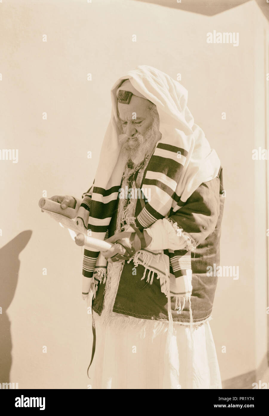 Yemenite Rabbi Avram arrayed for prayer, reading scrolls. 1934 Stock ...