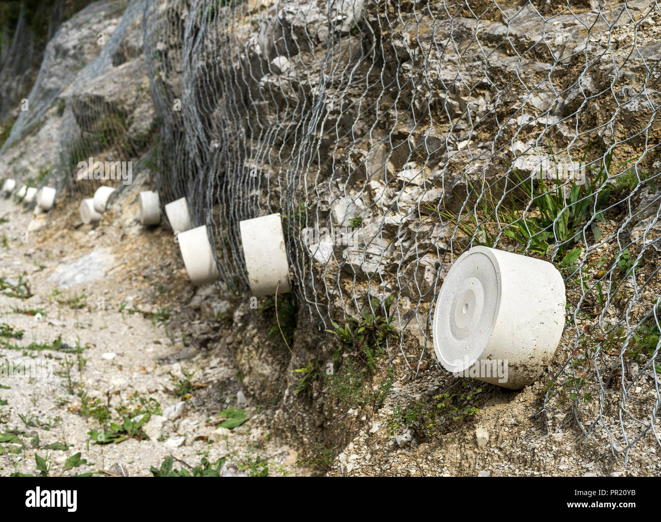 Metal net for falling rock protection Stock Photo - Alamy