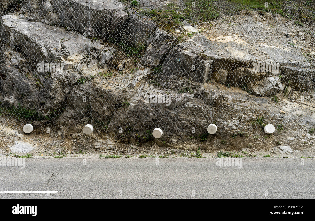 Metal net for falling rock protection Stock Photo - Alamy