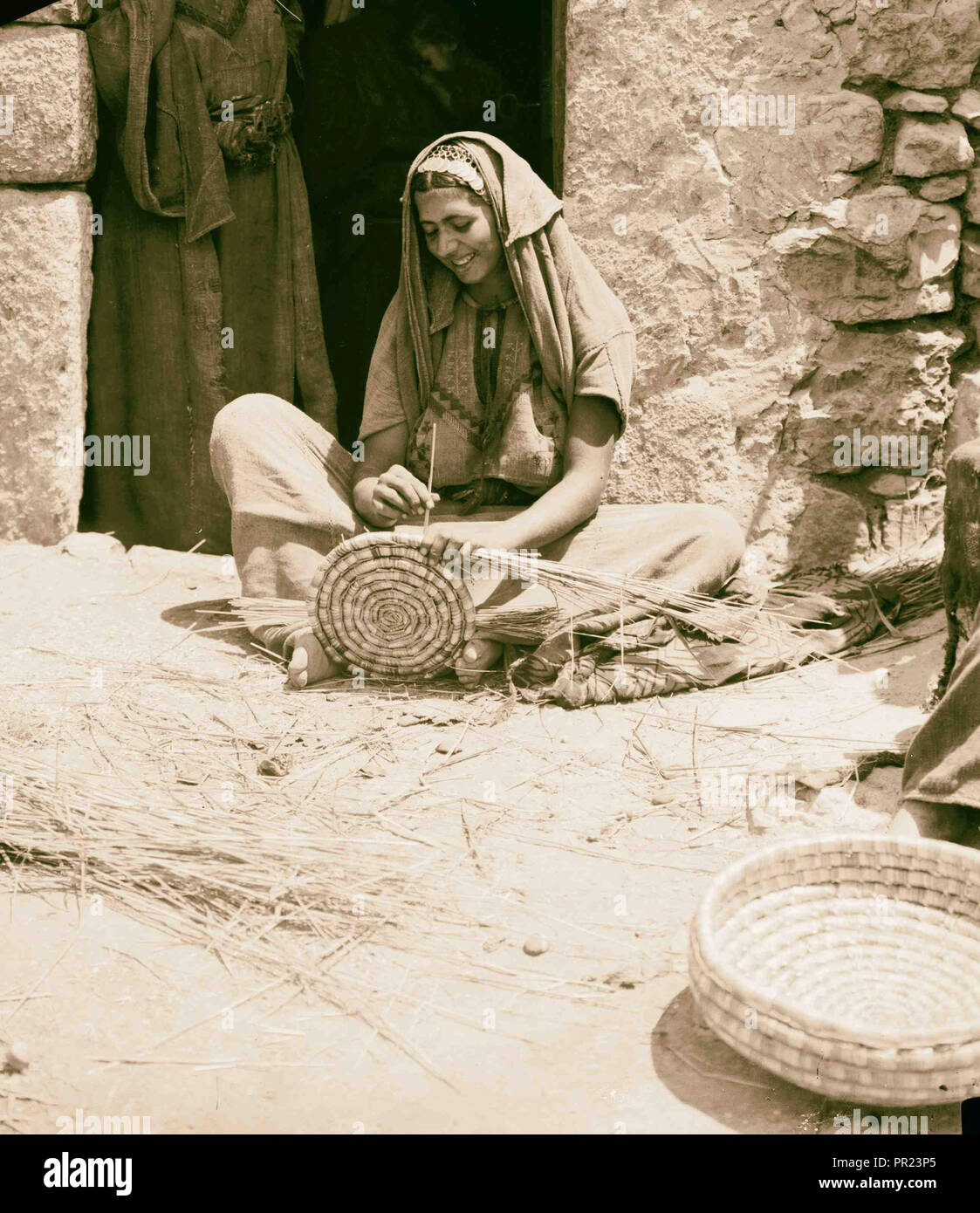 Woman weaving reed baskets. 1898 Stock Photo - Alamy