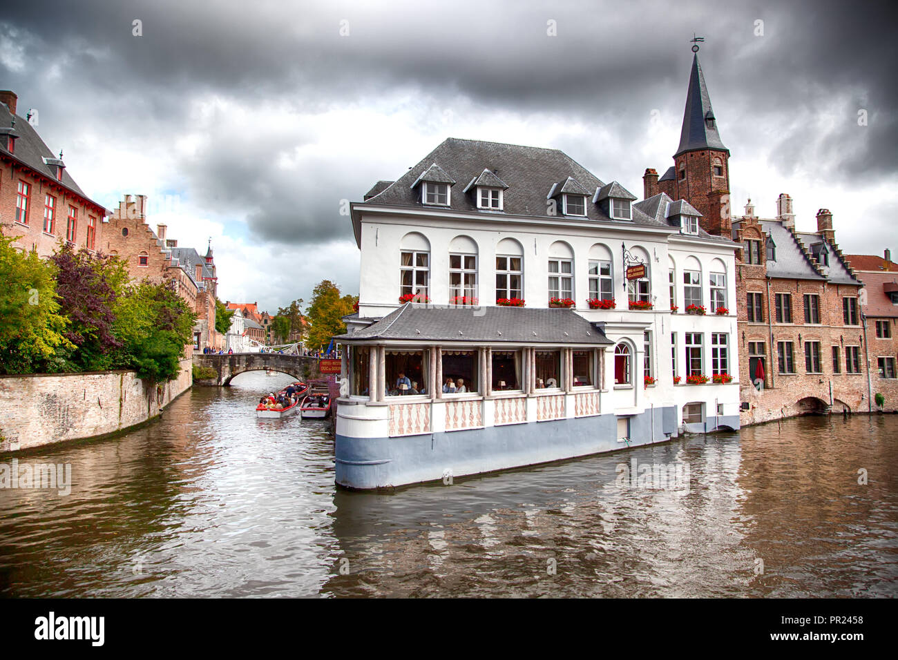 Medieval channels of Bruges, detail of tourism in a city of Belgium ...