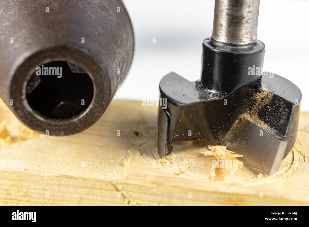 Drilling holes with a wood drill in a workshop. Joinery works performed ...